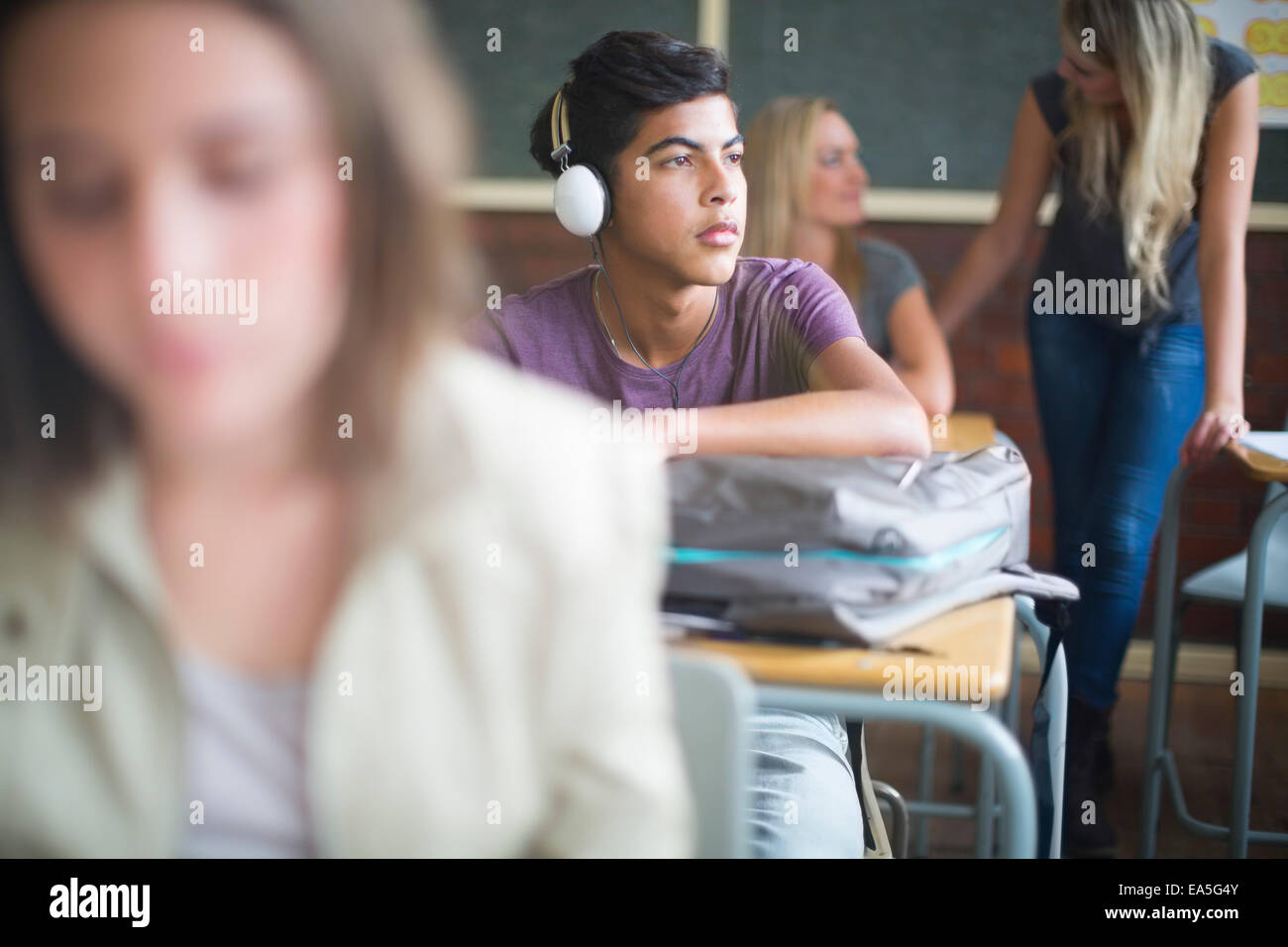 Student wearing headphones in classroom Stock Photo - Alamy