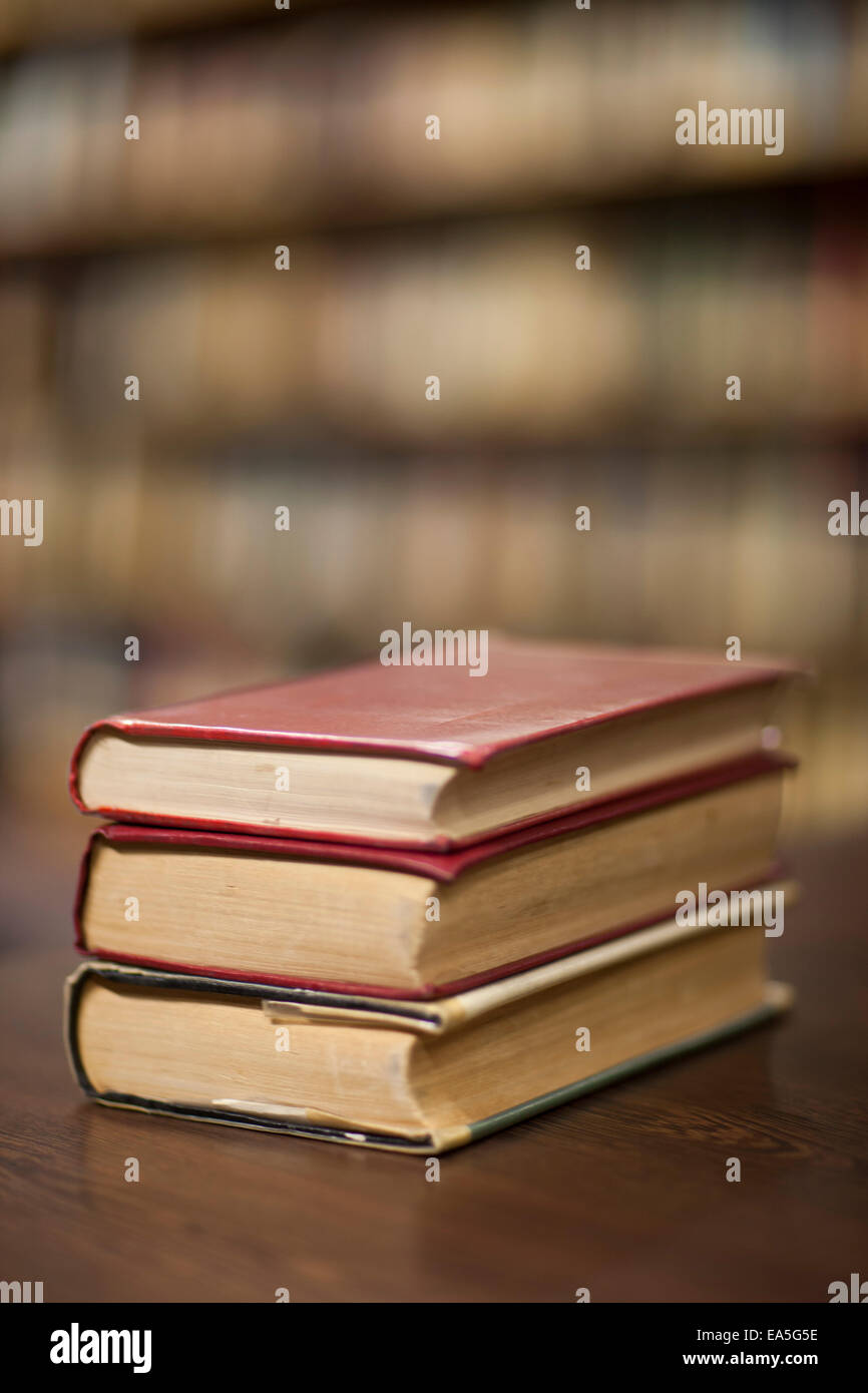 Books on table in a library Stock Photo - Alamy
