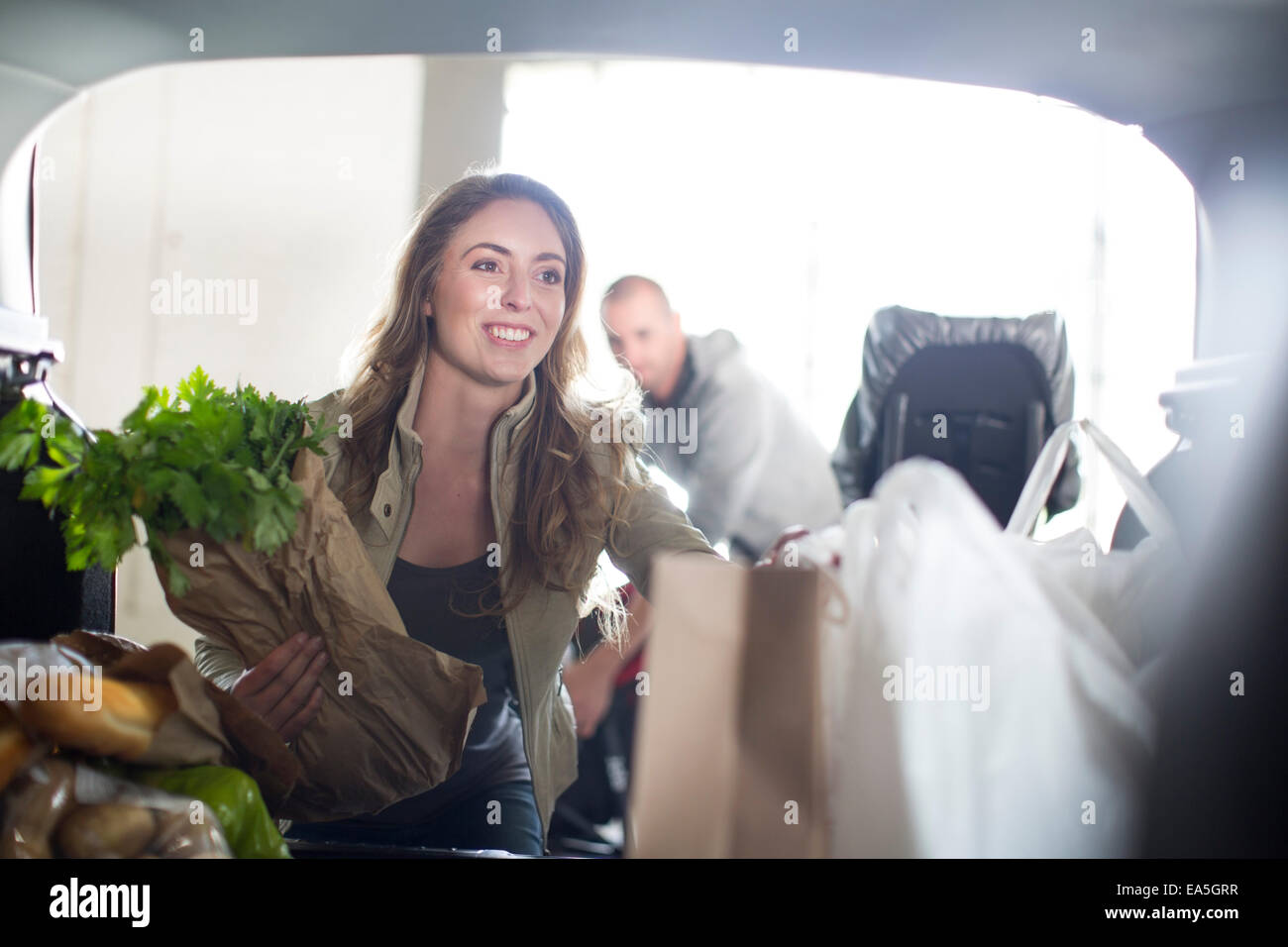 Family at shopping mall, loading car Stock Photo - Alamy