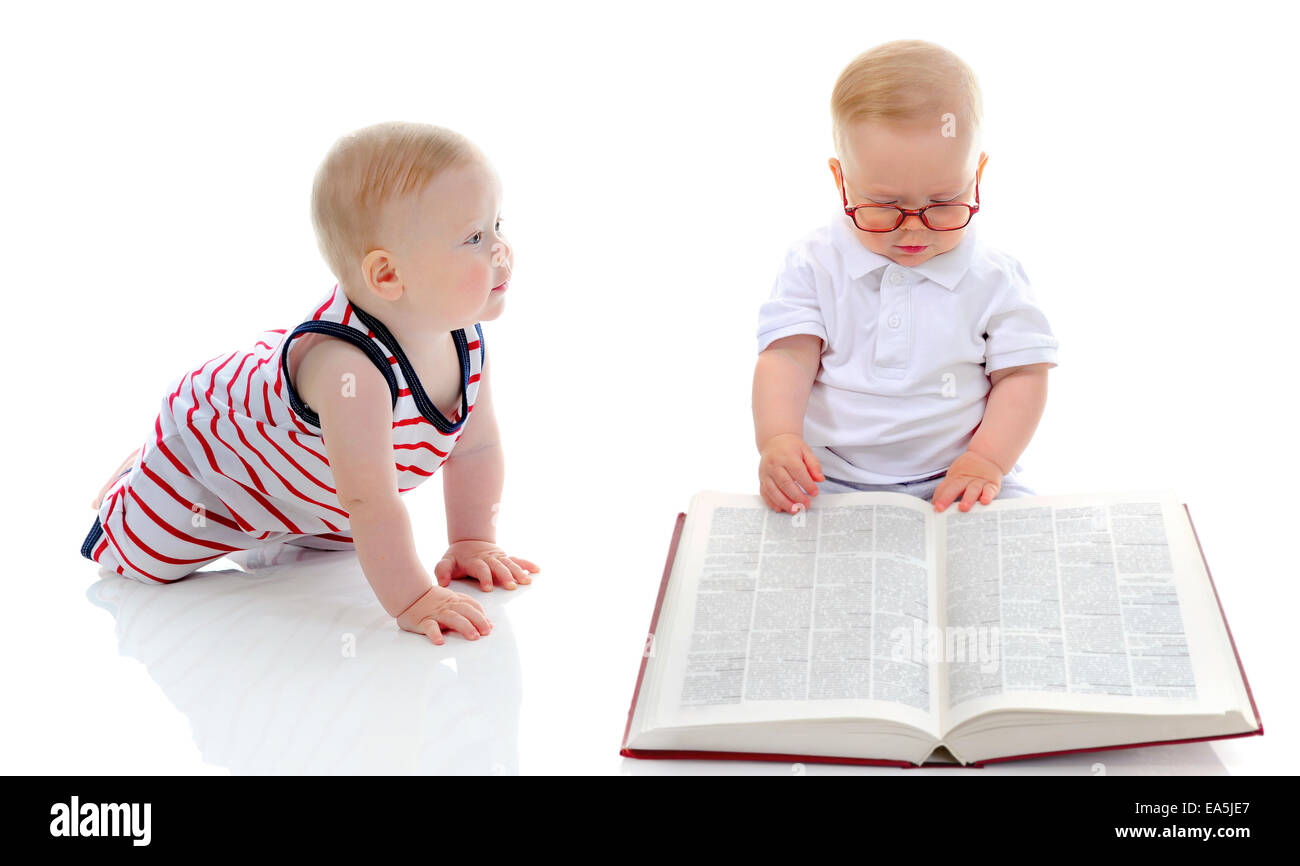 Little smart boy reads a big book Stock Photo - Alamy