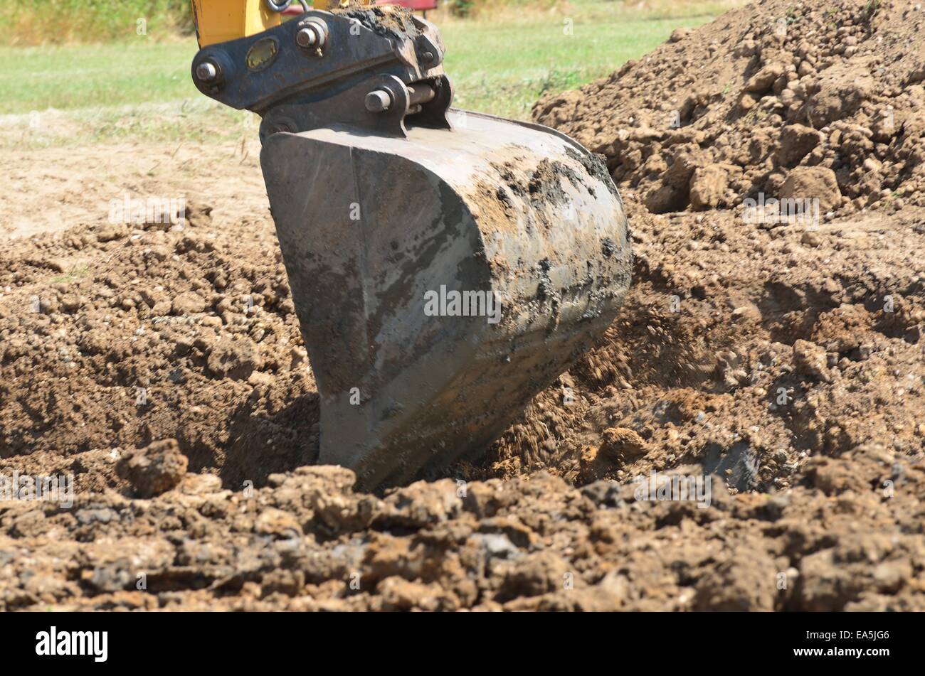 Mechanical digger on ground Stock Photo - Alamy