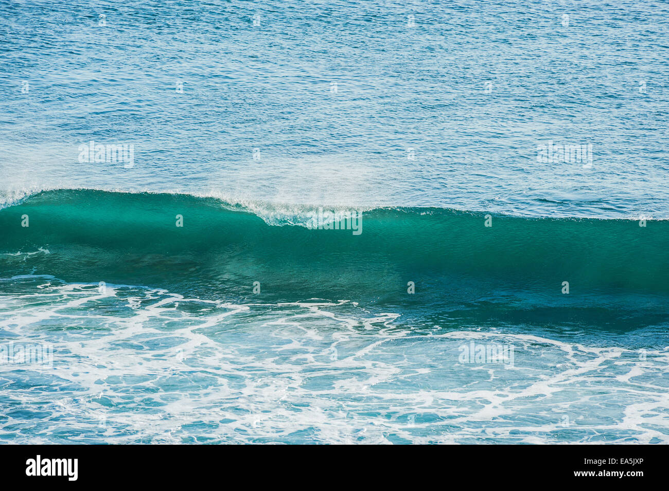 swirled blue colored ocean wave Stock Photo - Alamy