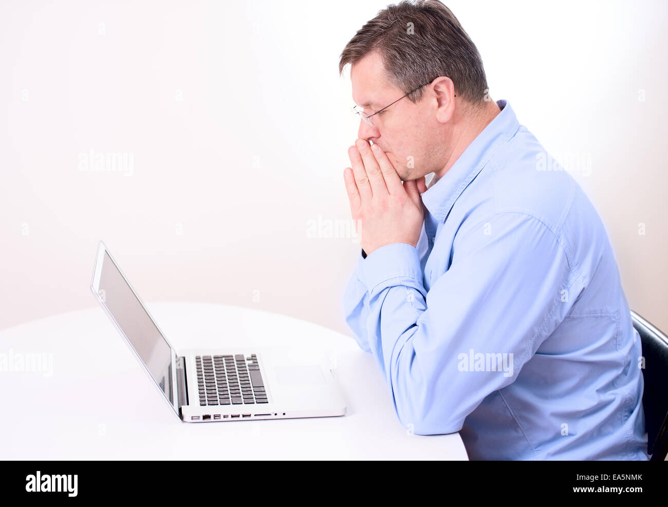 Man on front of laptop Stock Photo - Alamy