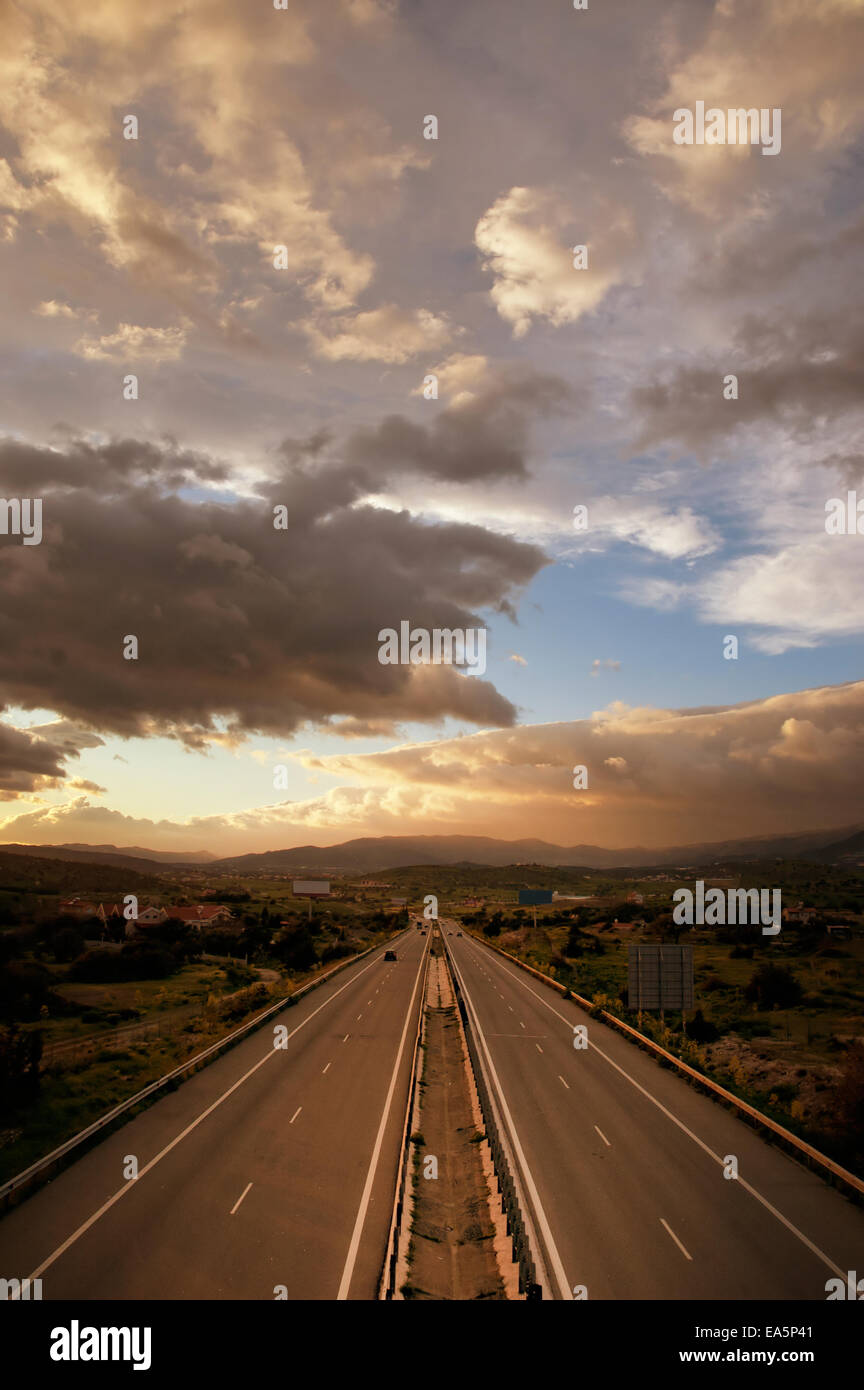 Beautiful dramatic cloudy sunset sky over highway Stock Photo - Alamy