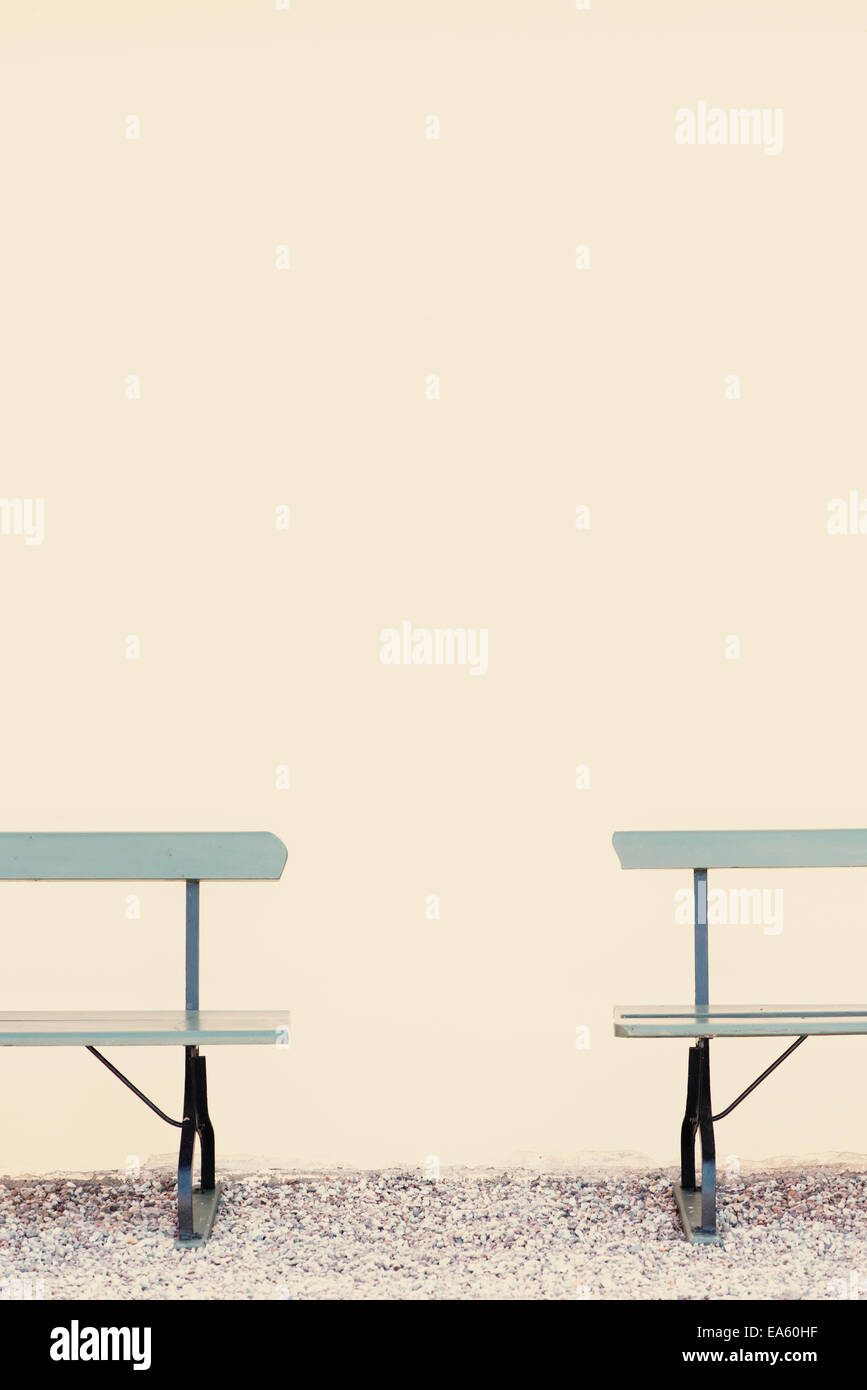 Two empty benches in front of wall Stock Photo - Alamy