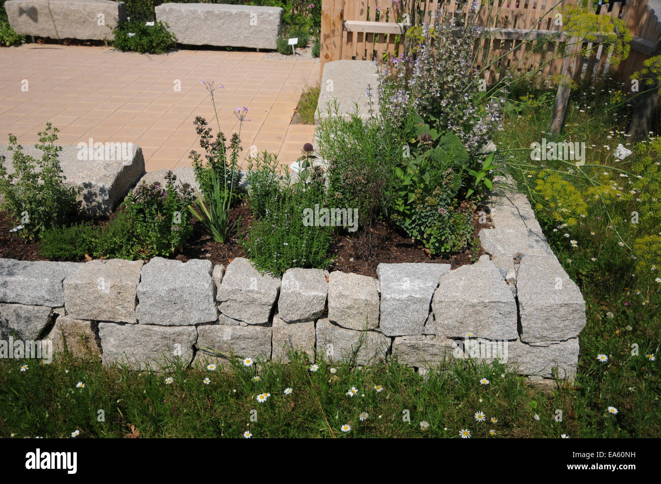 Raised bed made of granite stones Stock Photo - Alamy