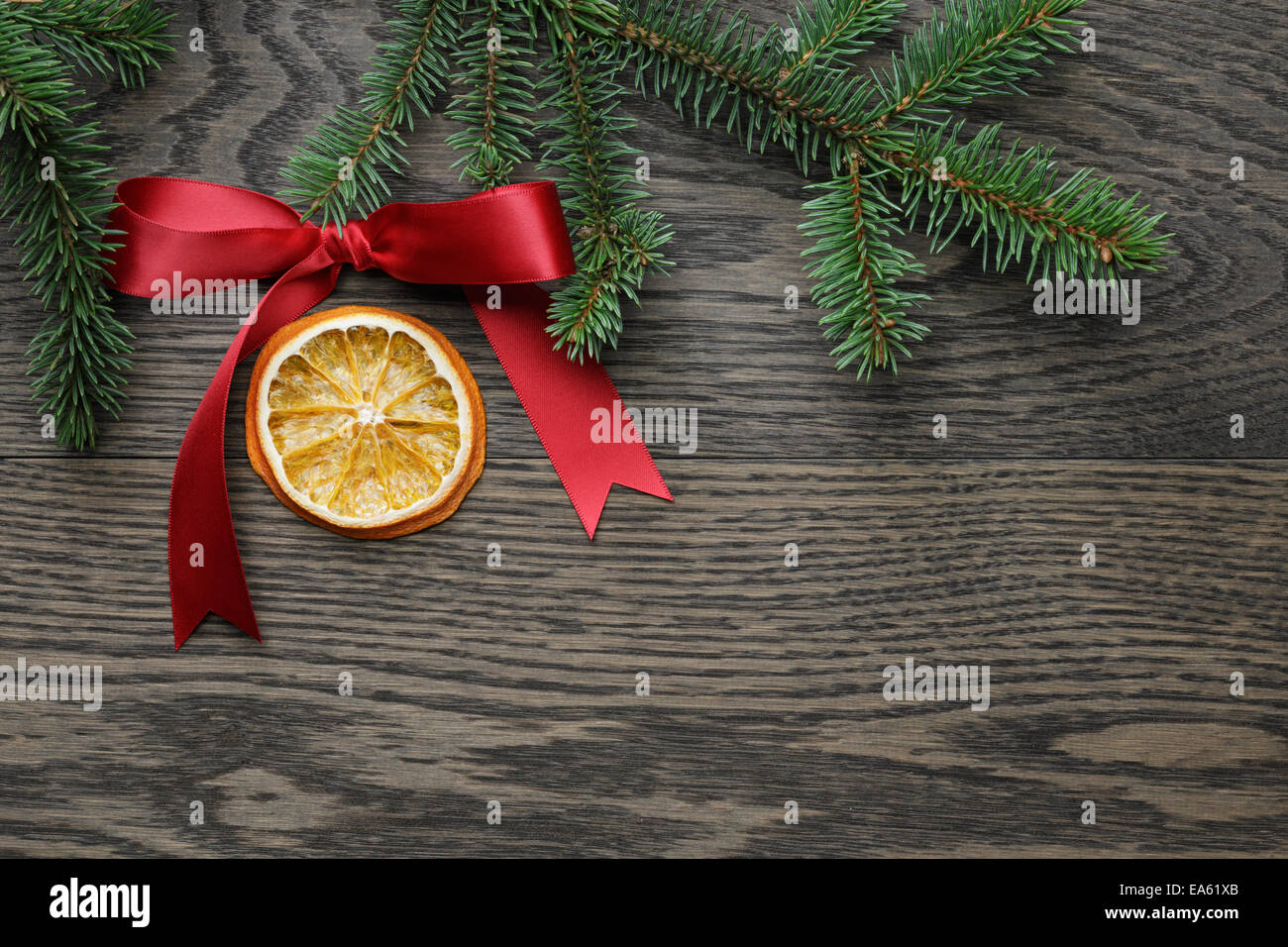 spruce twig with red bow and orange slice, christmas background Stock ...