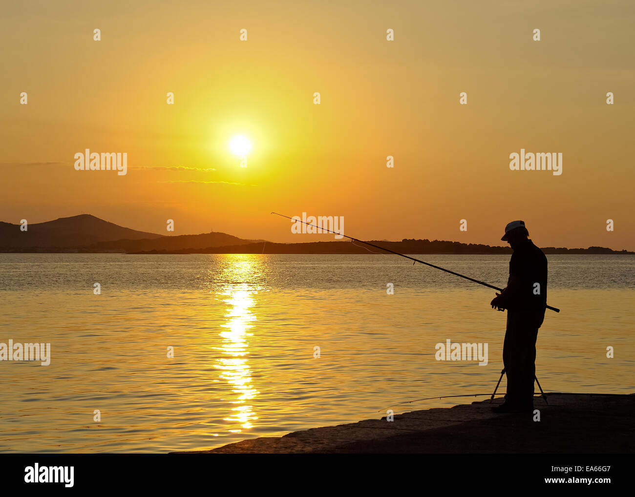 Fishermen on the sea at sunset Stock Photo - Alamy