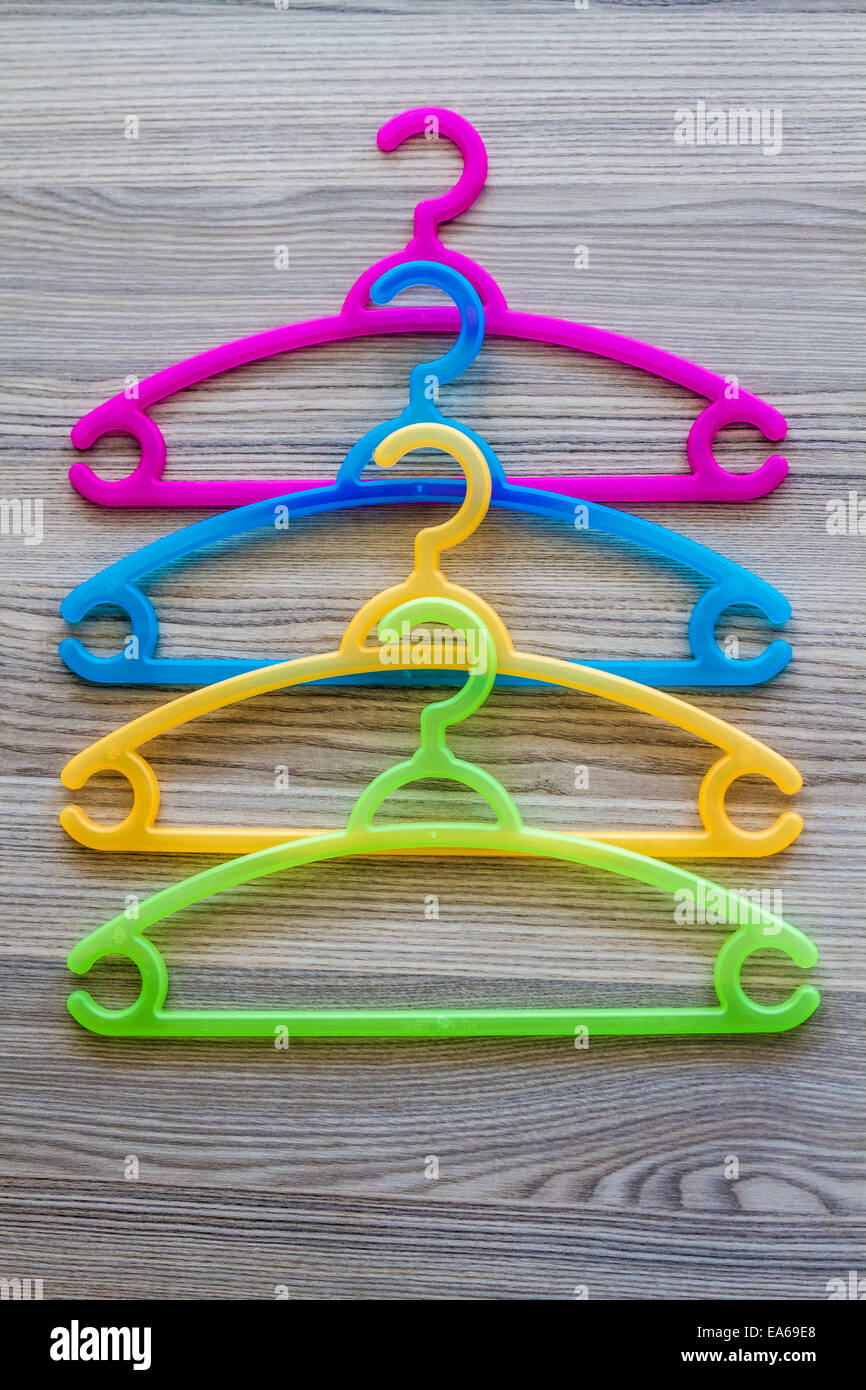 Colorful modern plastic clothes hanger on a wooden background Stock ...