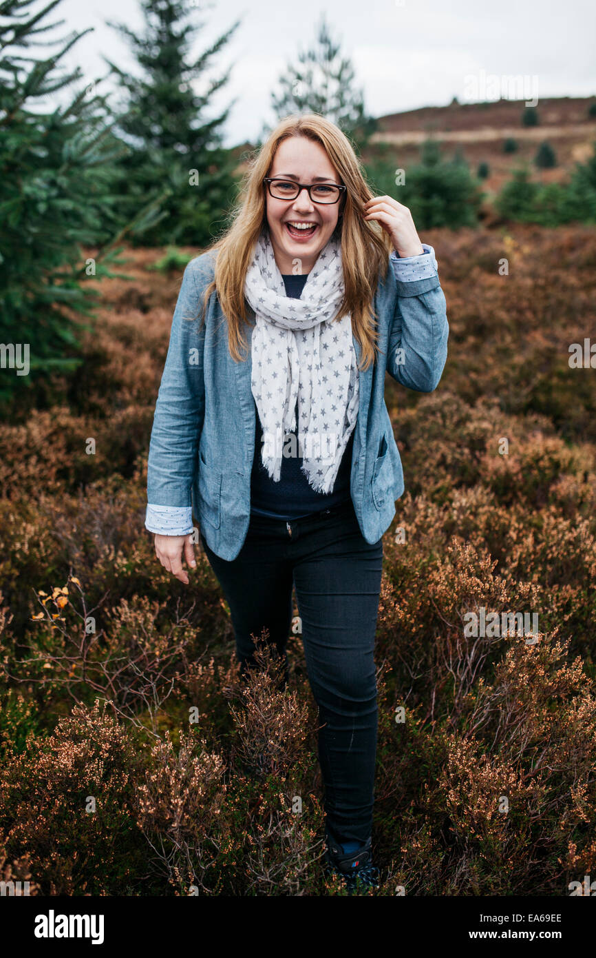 Happy woman walking through the heather Stock Photo - Alamy