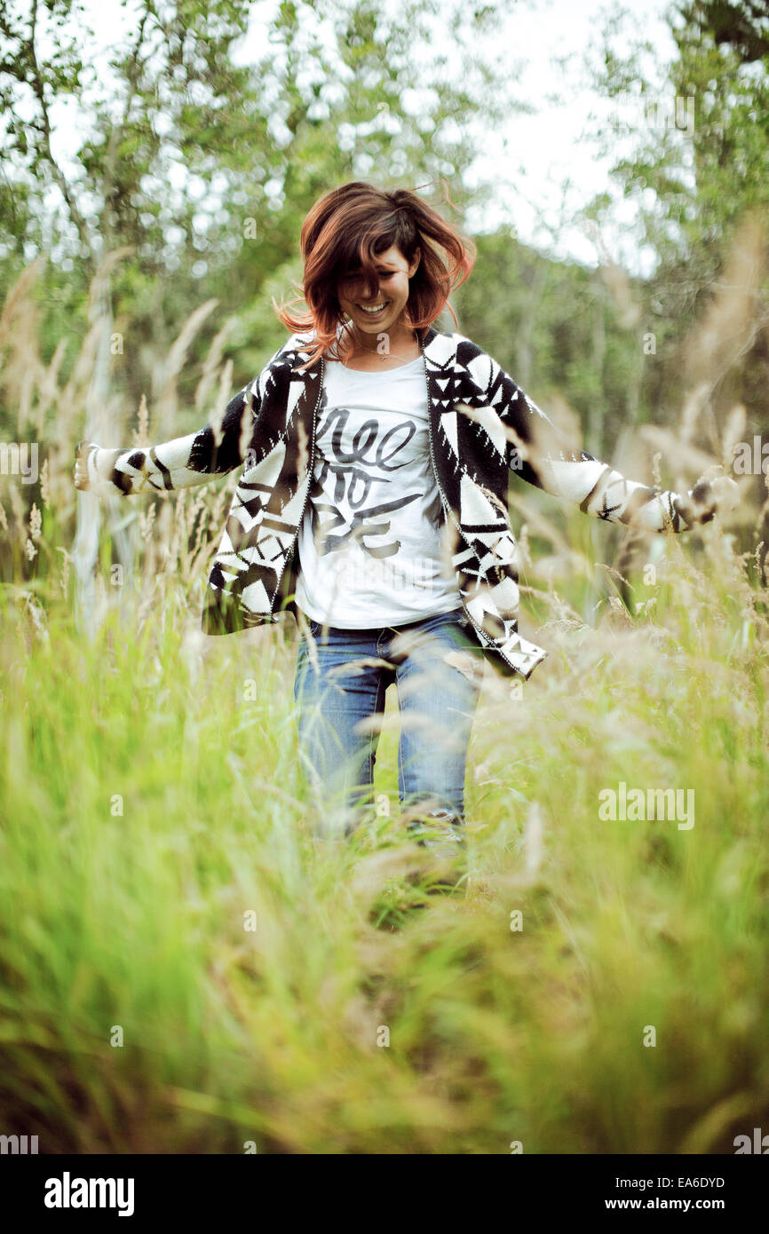 Teenage girl dancing in grass Stock Photo - Alamy