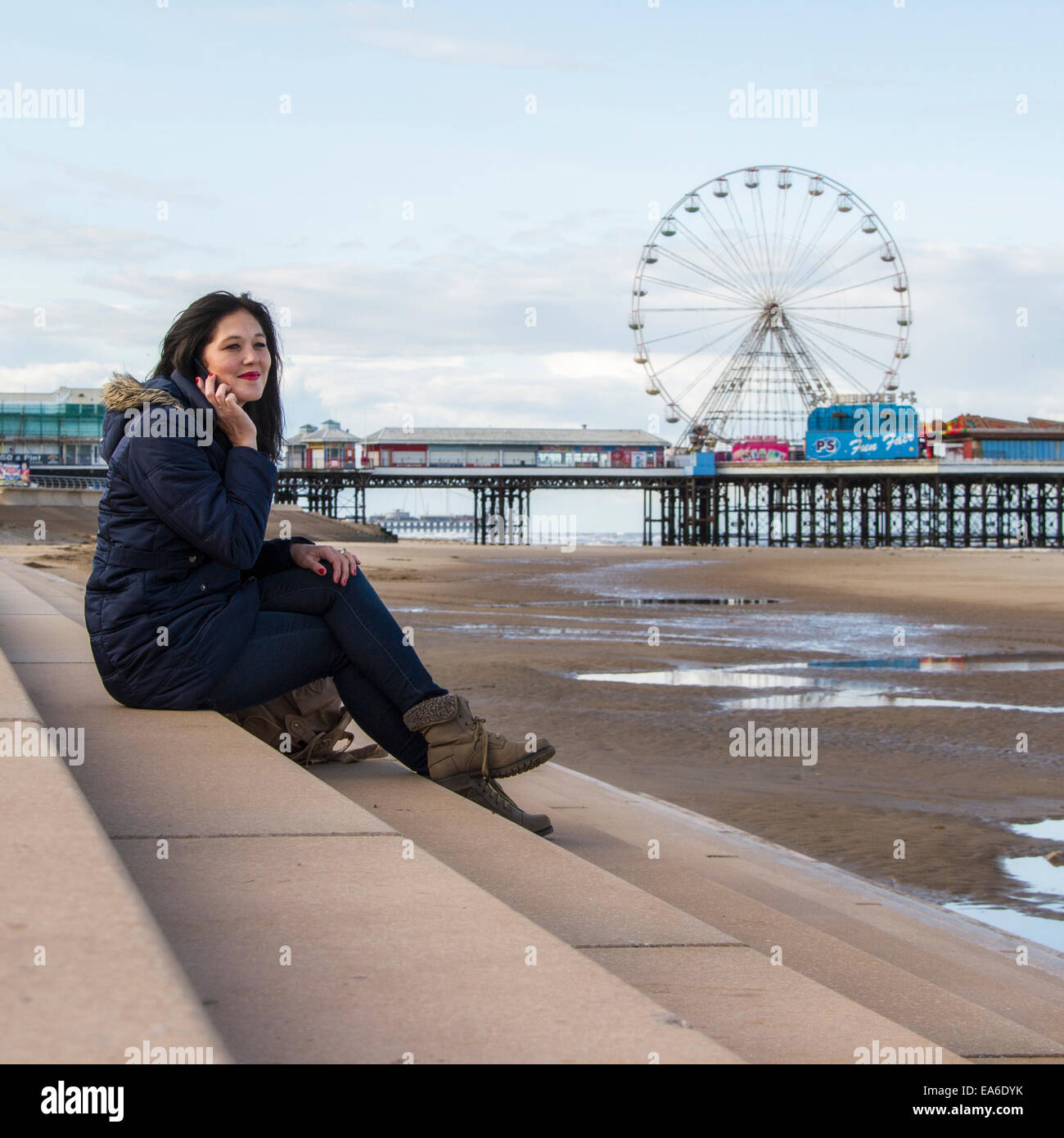 UK, England, Blackpool, Woman with phone on steps Stock Photo - Alamy