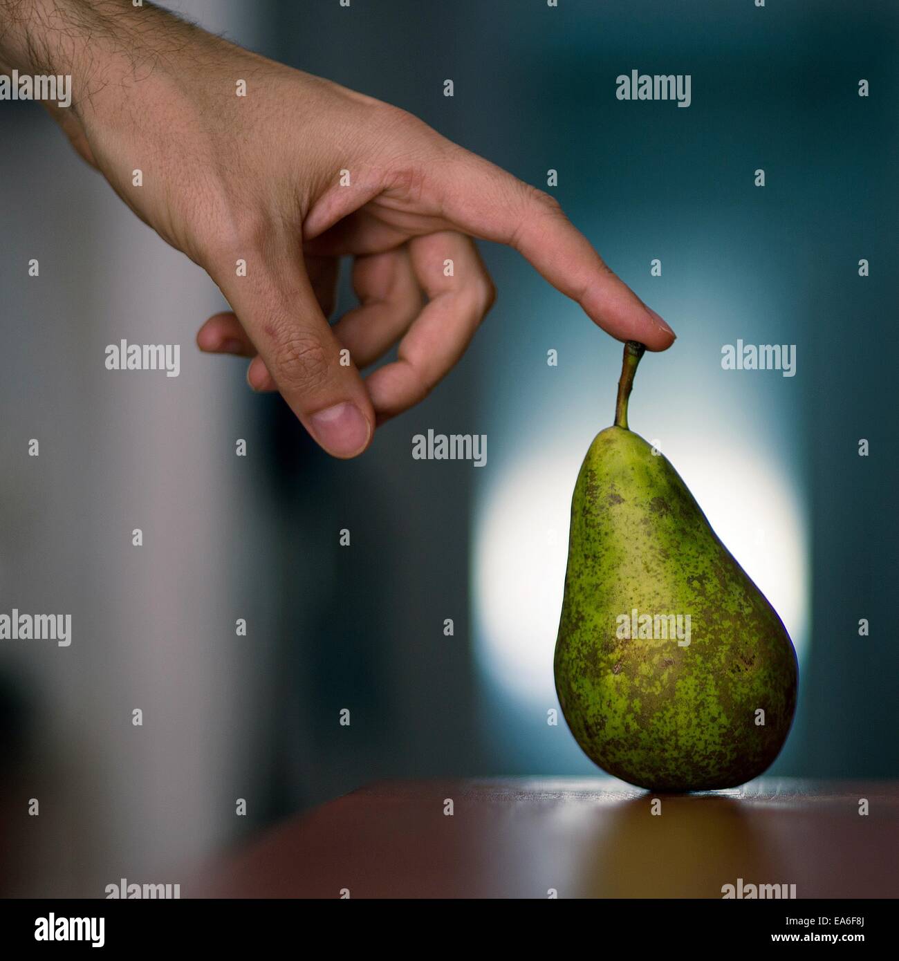 Man touching a pear Stock Photo - Alamy