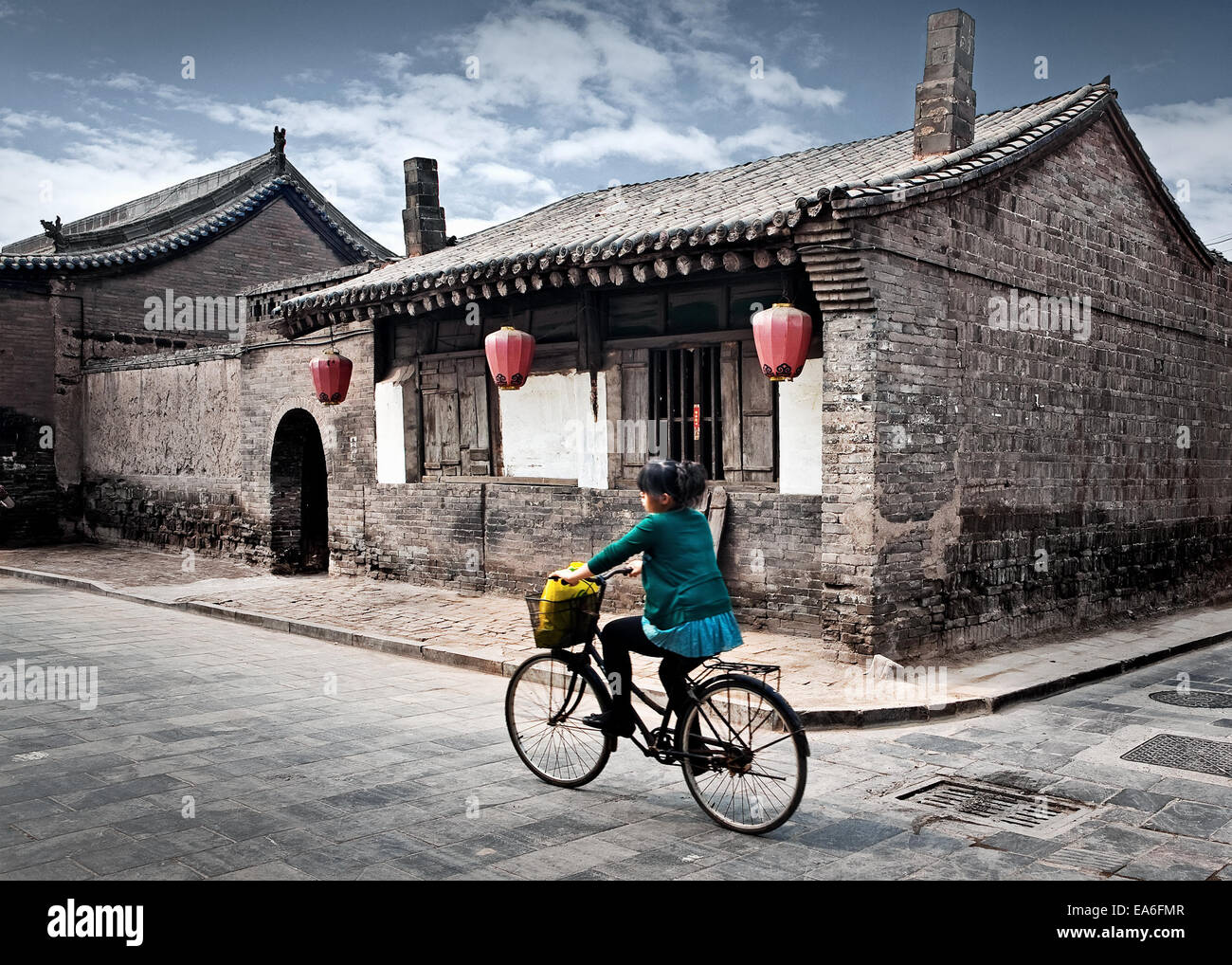 China, Pingyao, Girl riding bicycle Stock Photo - Alamy