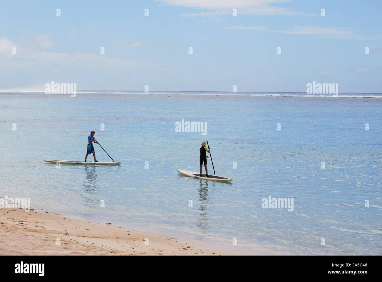 Boy and girl paddleboarding, Rarotonga, Cook Islands Stock Photo - Alamy