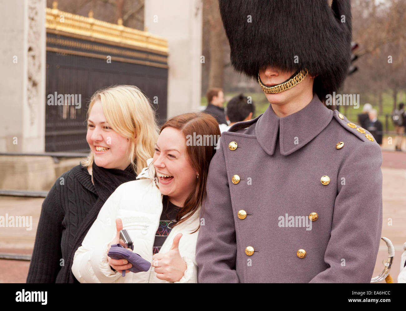 A guardsman in bearskin unembarrassed by the behaviour of tourists at ...