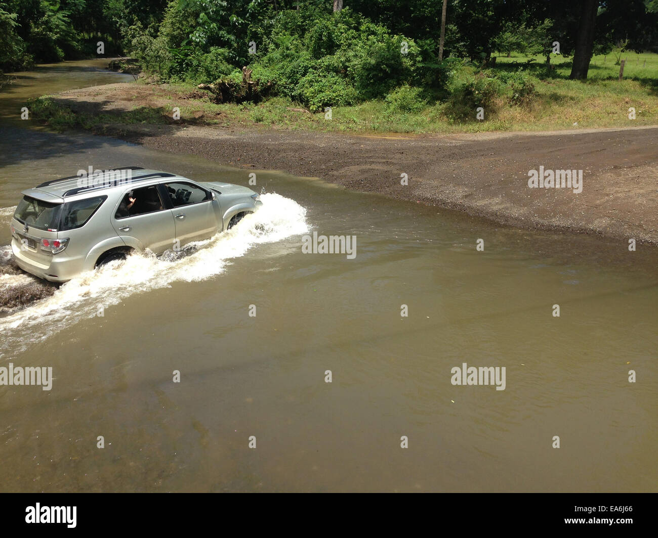 Car driving through river Stock Photo - Alamy