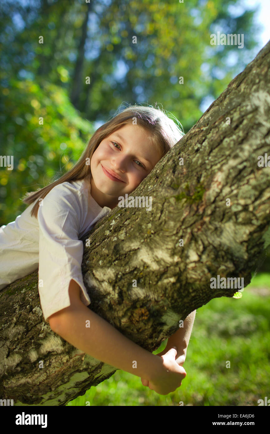 girl lying on a tree Stock Photo - Alamy