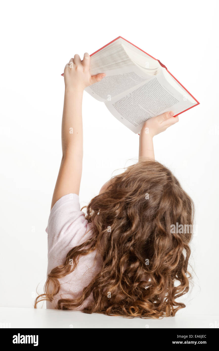 girl holding a book over a Stock Photo - Alamy
