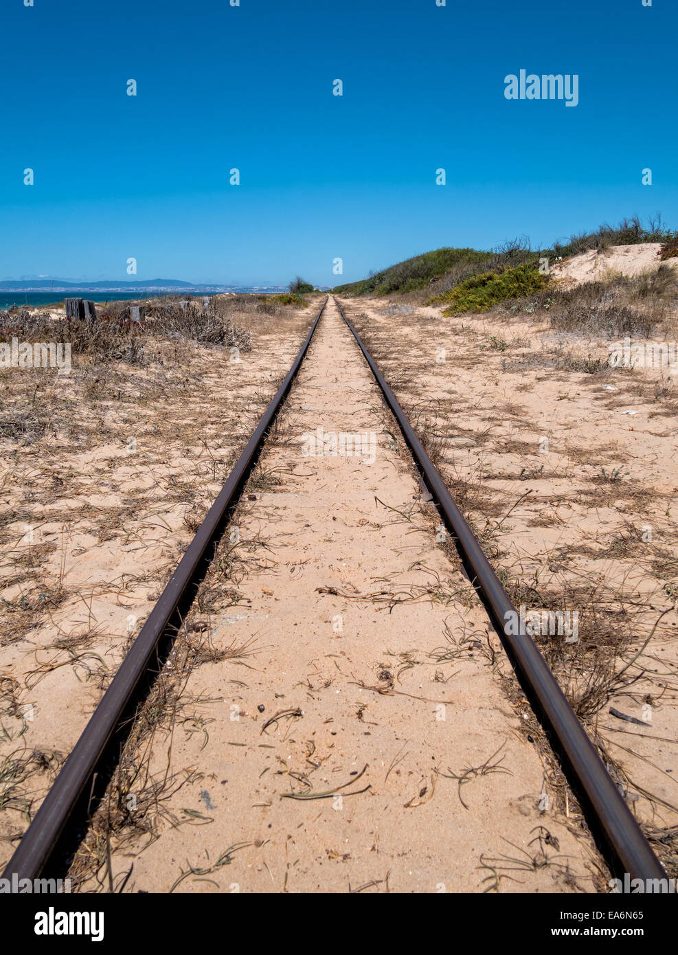Steel Railroad Tracks on Sand Beach, into horizon Stock Photo - Alamy