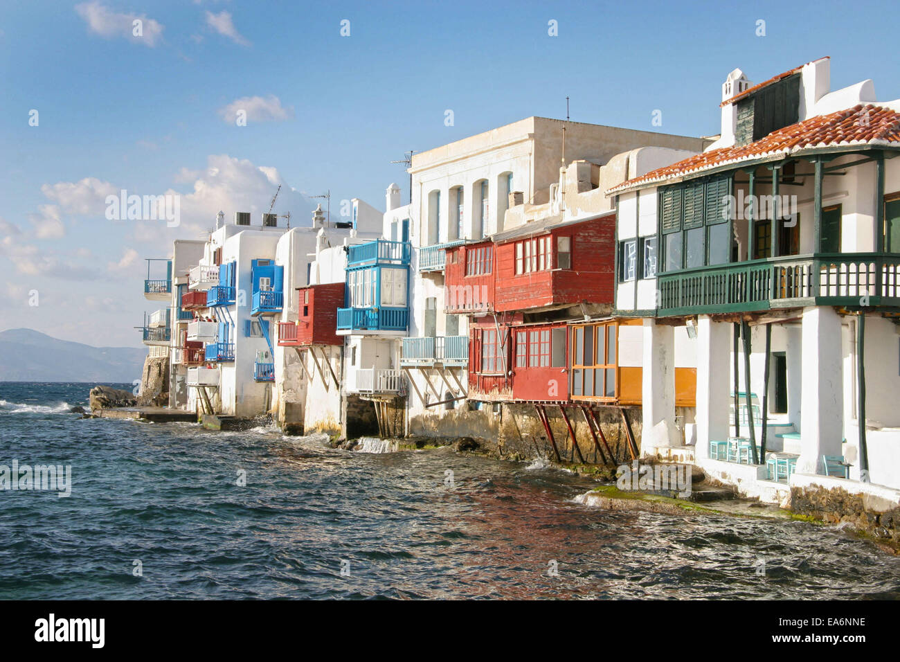 Traditional whitewashed buildings built on the edge of the coastline ...