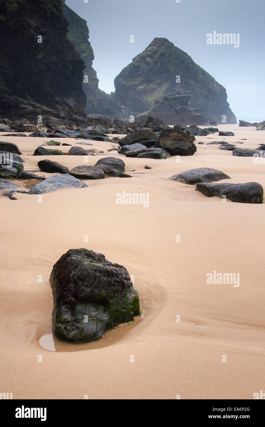 Sand and rocks on the beach at Bedruthan steps in Cornwall on a moody ...
