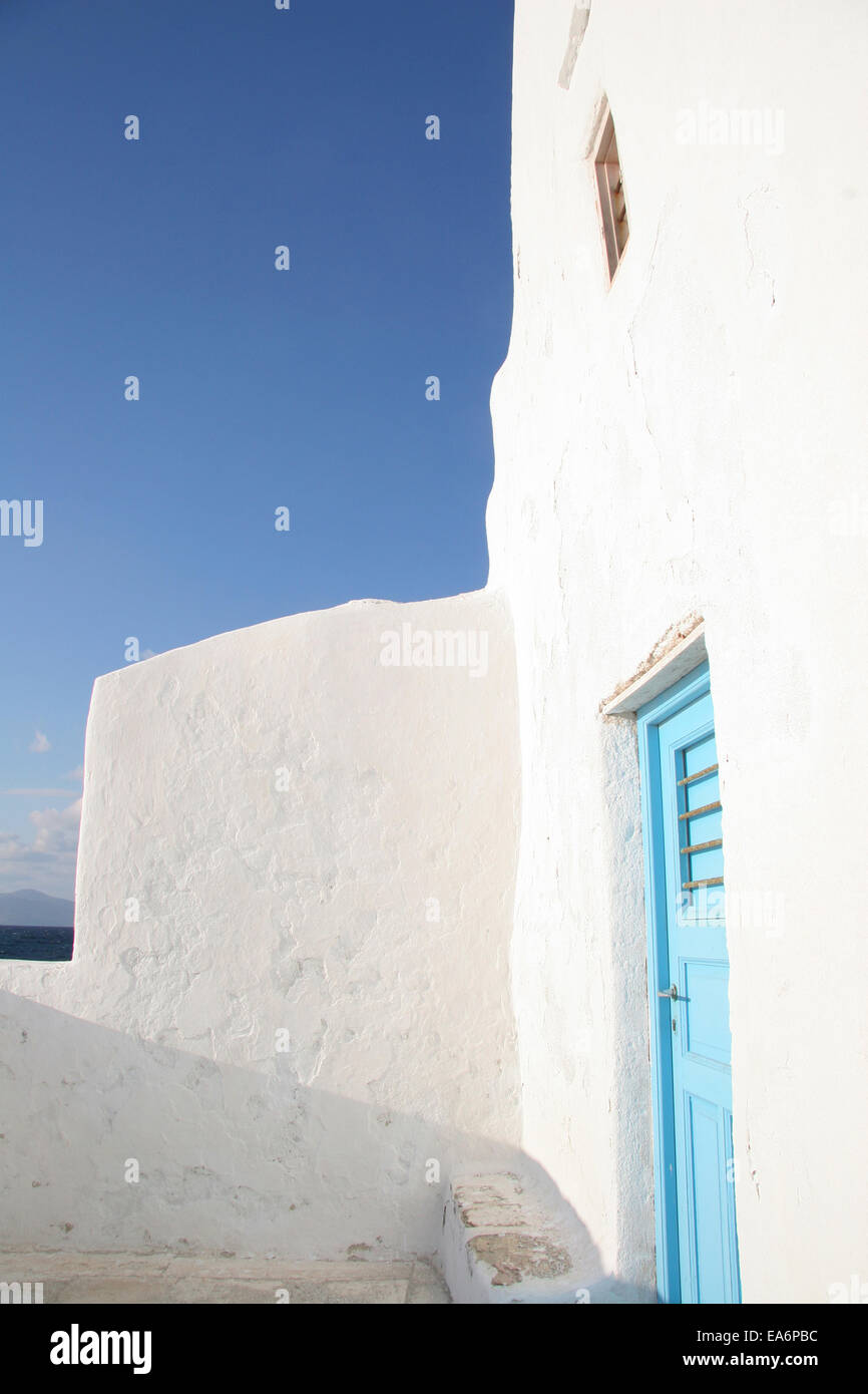 Traditional whitewashed building with blue painted door on a beautiful ...