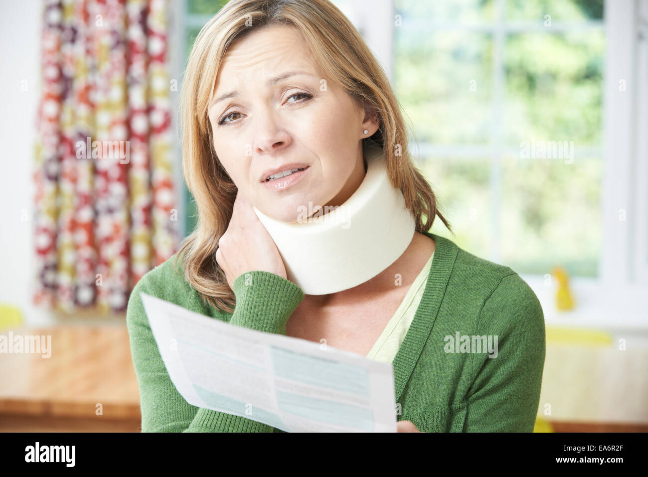 Woman Reading Letter After Receiving Neck Injury Stock Photo - Alamy