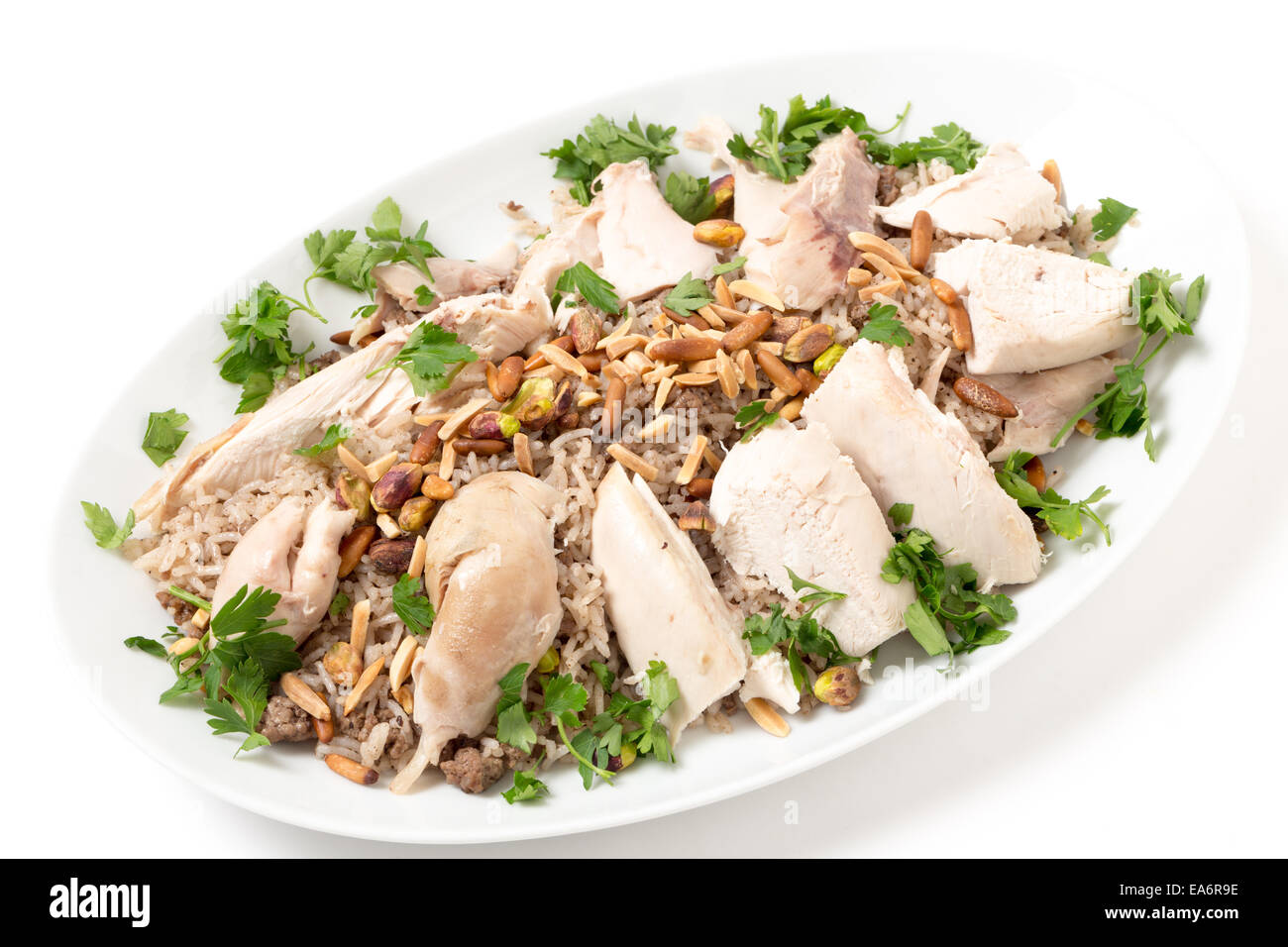 Serving dish of Lebanese chicken and spiced rice with meat, roast nuts ...