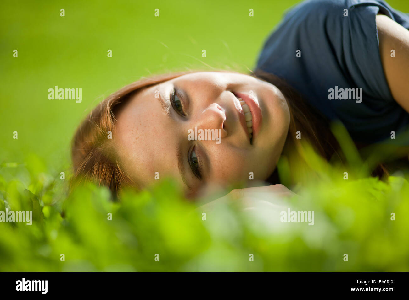 girl lying on the grass and smiling Stock Photo - Alamy
