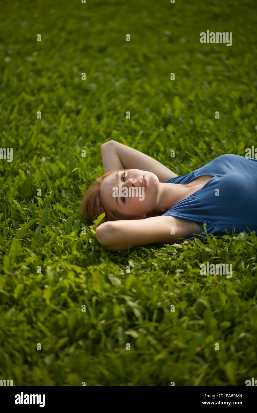 girl lying on the grass and smiling Stock Photo - Alamy