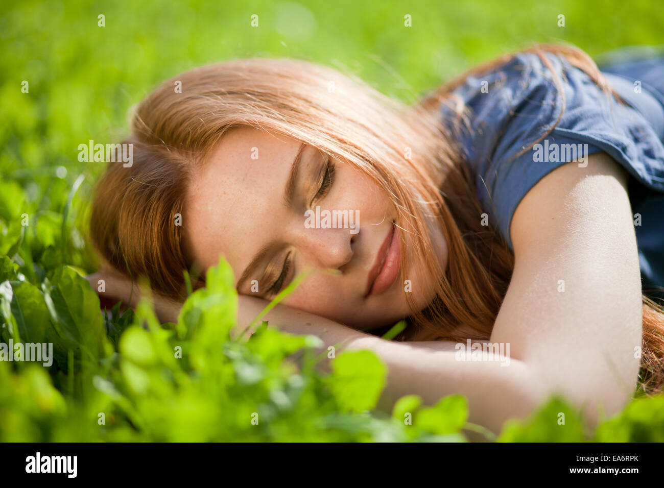 girl lying on the grass and sleeping peacefully Stock Photo - Alamy
