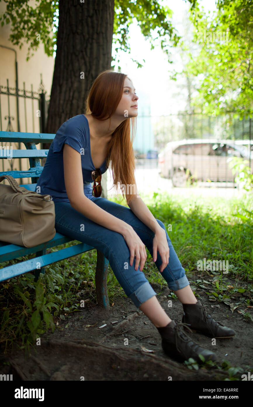 Sad girl sitting on bench hi-res stock photography and images - Alamy