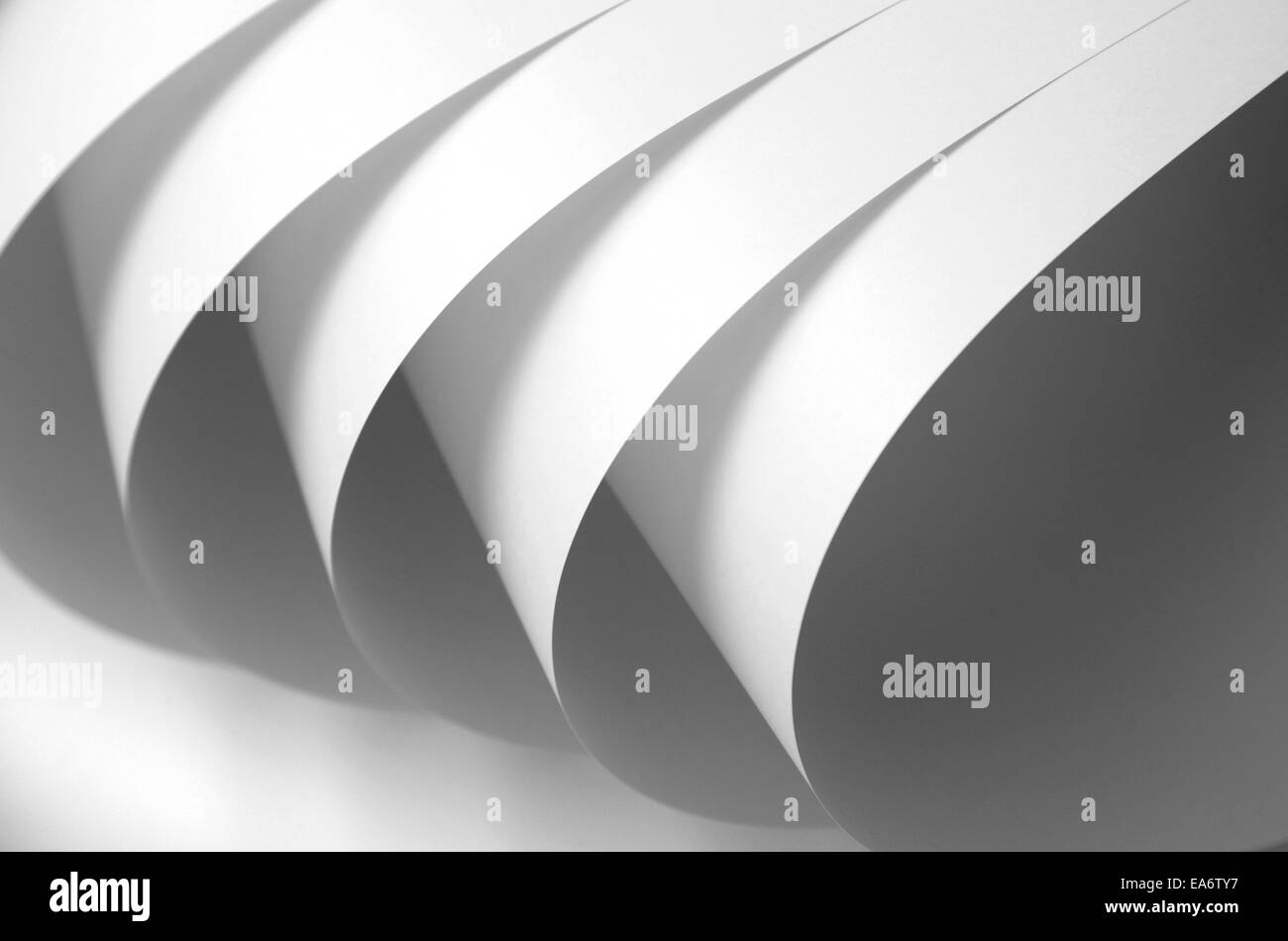 Sheets of paper being curled Stock Photo - Alamy