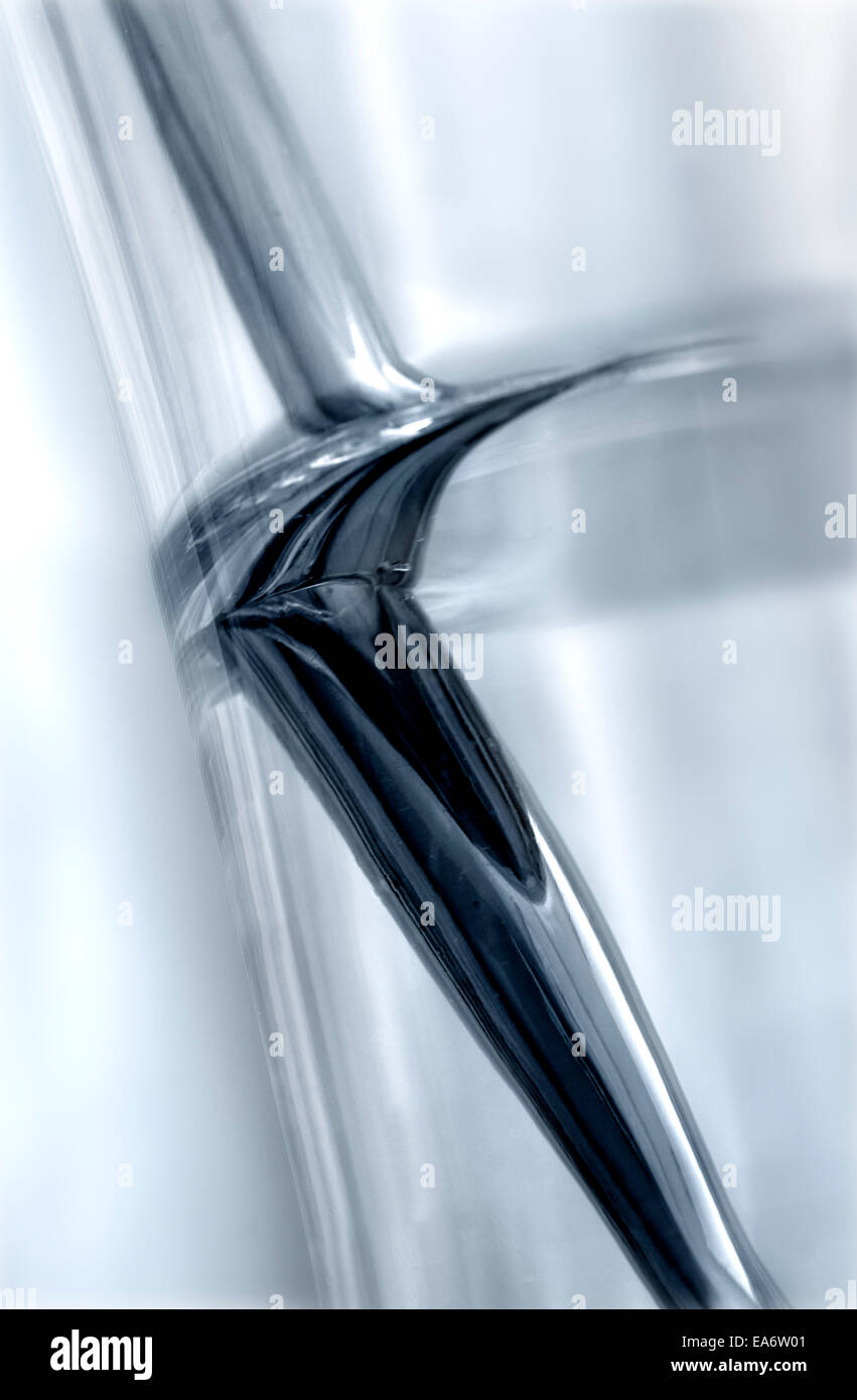 A spoon in a glass of water showing refraction Stock Photo - Alamy