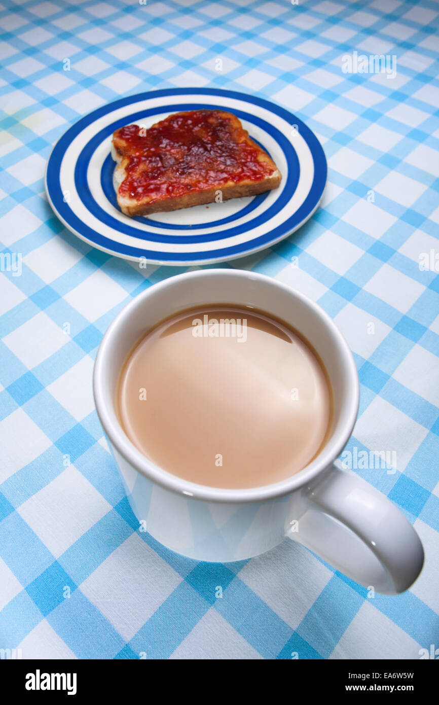 Jam on toast and a mug of tea on a check table cloth Stock Photo - Alamy
