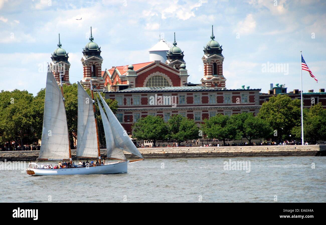 NYC: A graceful sloop sails past the Great Hall at Ellis Island ...
