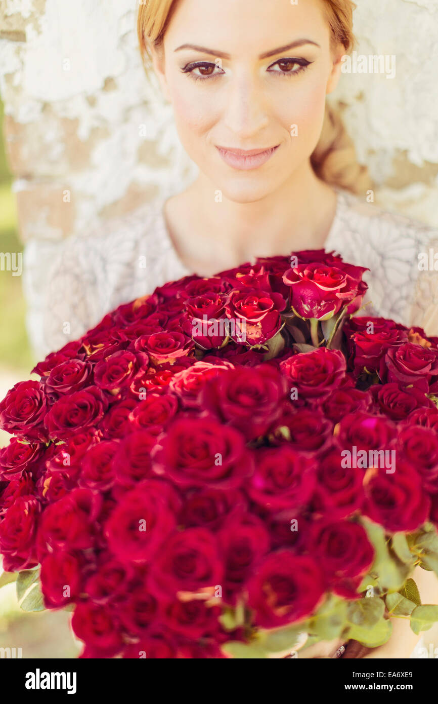 Young woman with red roses Stock Photo - Alamy