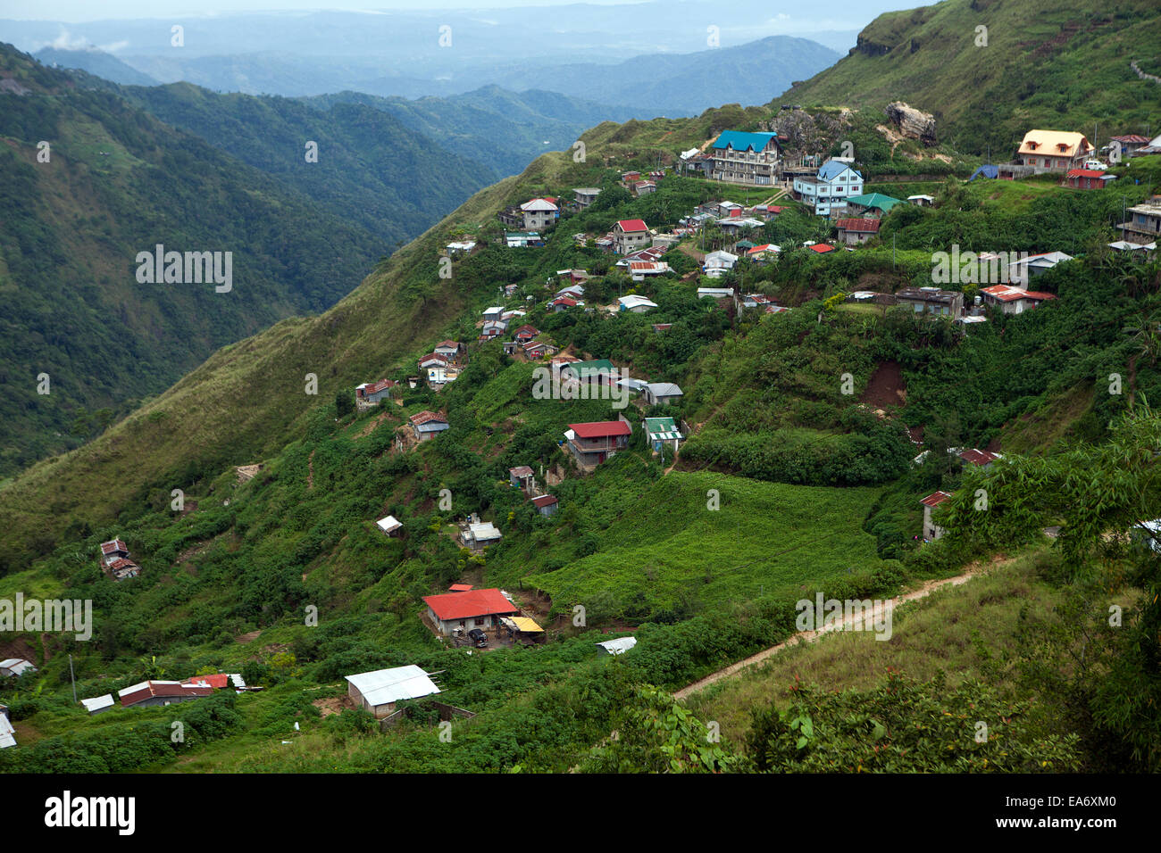 Homes and farms are perched on the steep slopes of mountainsides in ...