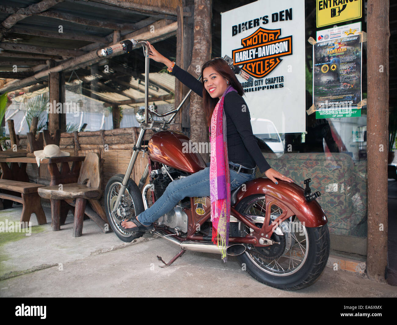 A beautiful Filipina models a Harley-Davidson chopper motorcycle ...