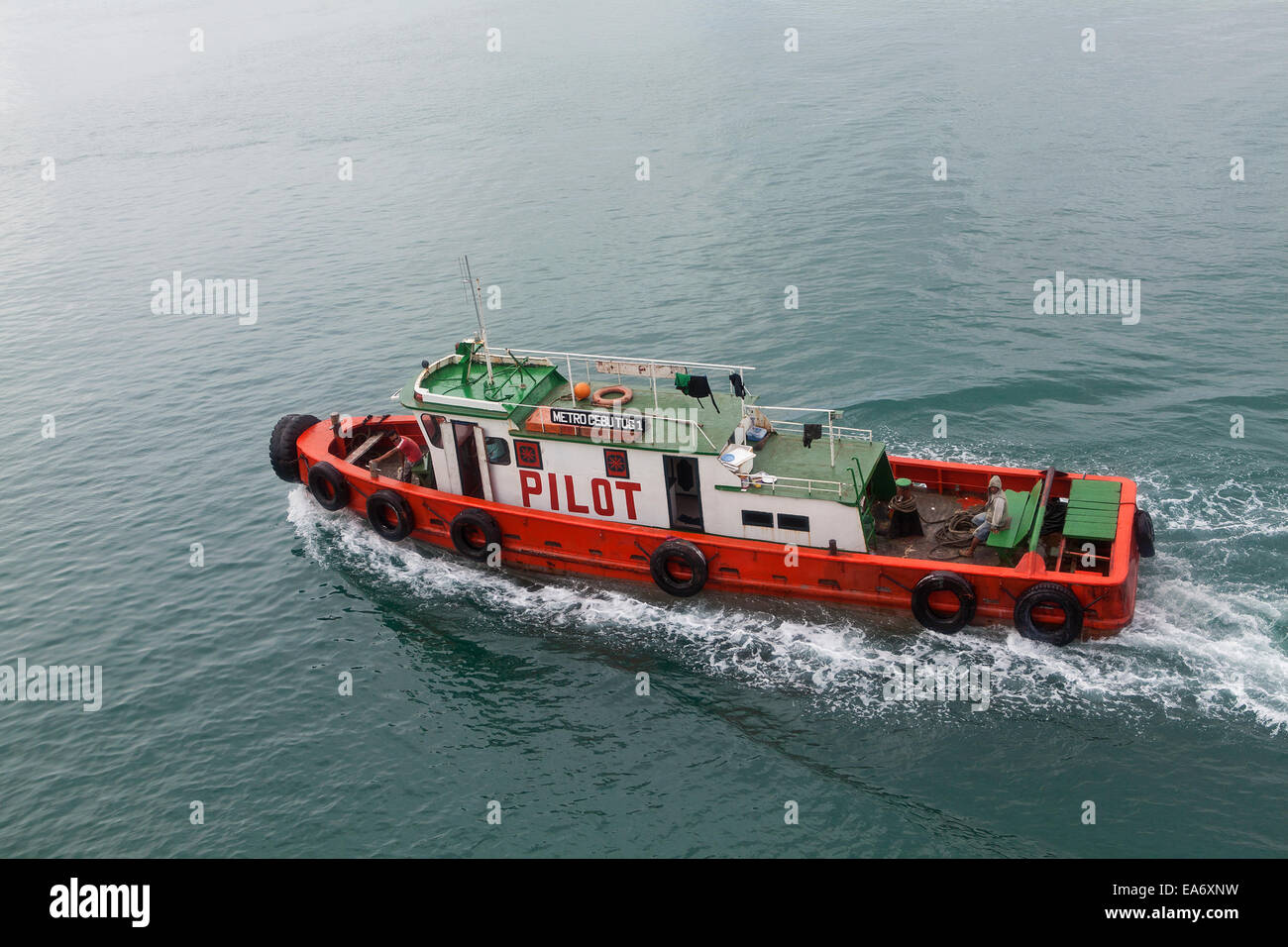 A pilot boat makes its way across the Cebu Strait in the Philippine ...