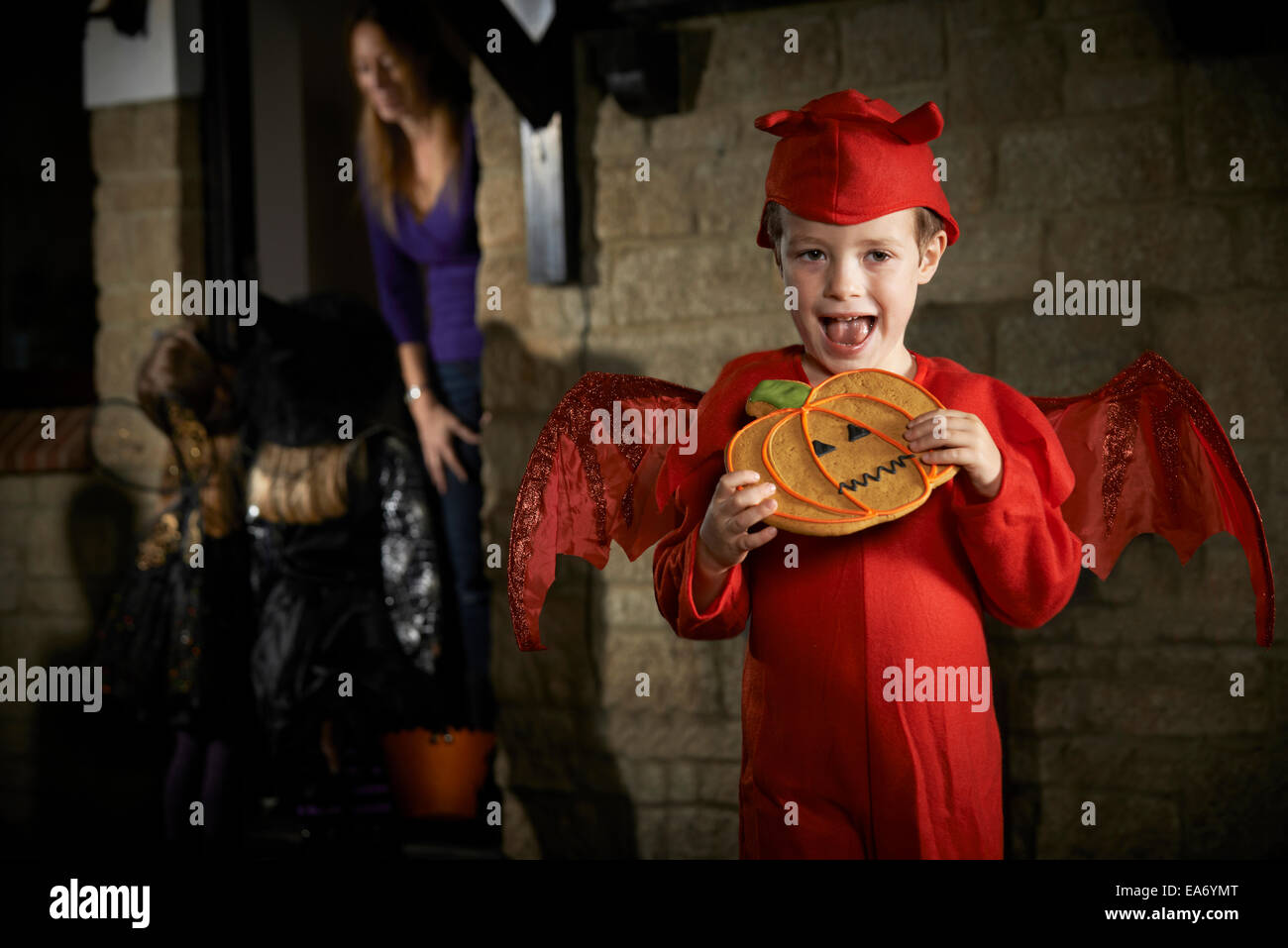 Halloween Party With Children Trick Or Treating In Costume Stock Photo ...
