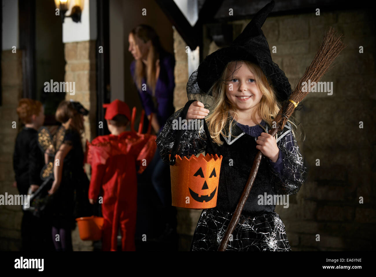 Halloween Party With Children Trick Or Treating In Costume Stock Photo ...