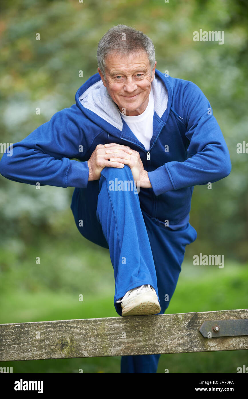 Senior Man Stretching On Countryside Run Stock Photo - Alamy