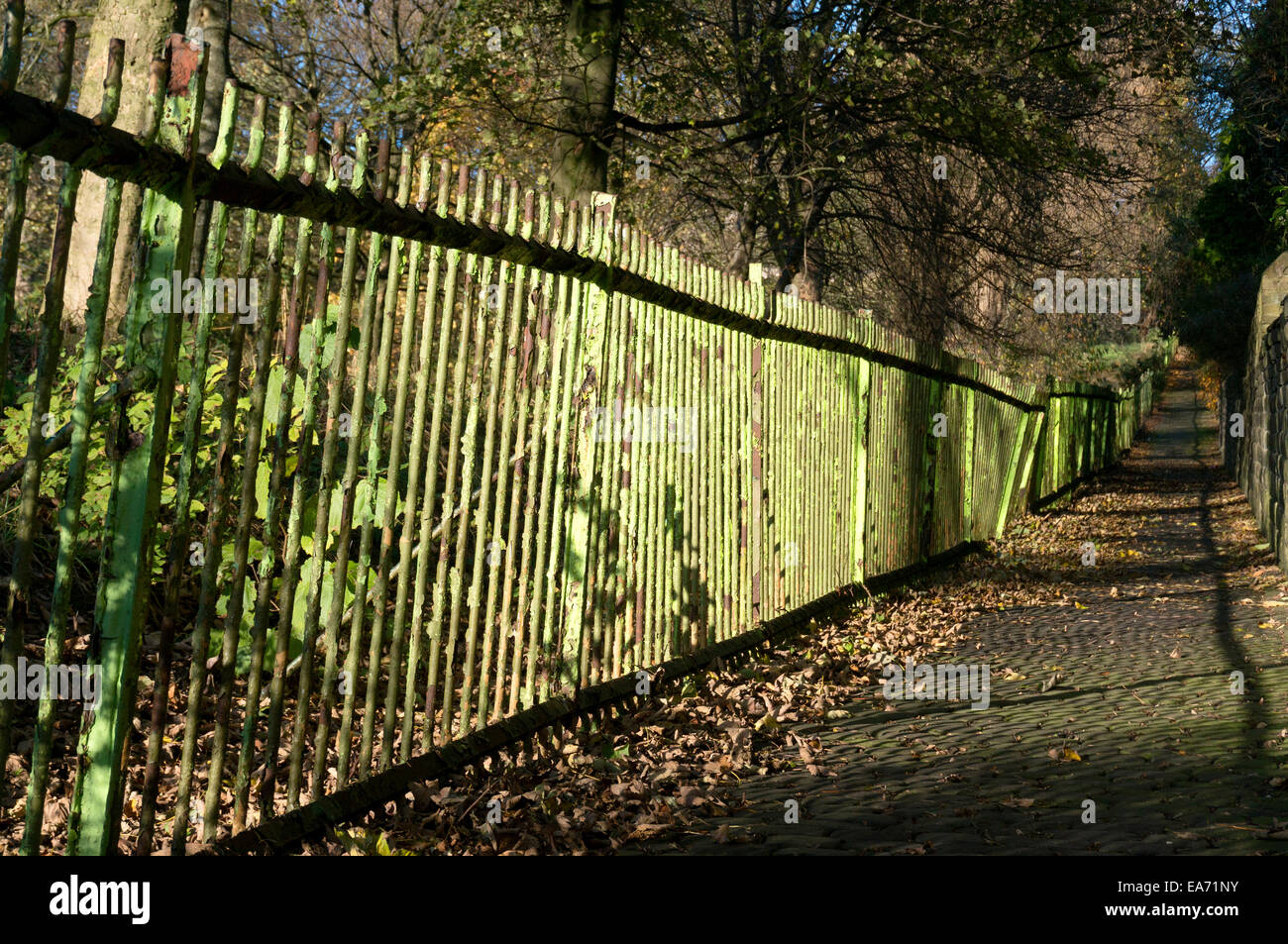 Cobbled path and green fence in the afternoon sun, Sowerby Bridge, West ...