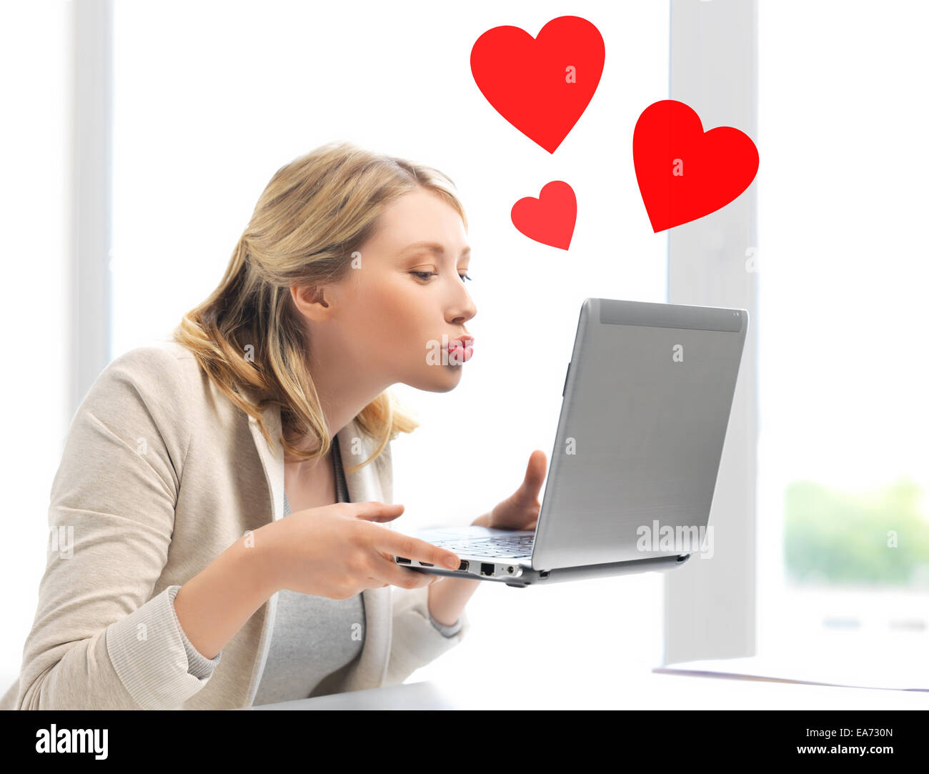 woman sending kisses with laptop computer Stock Photo - Alamy