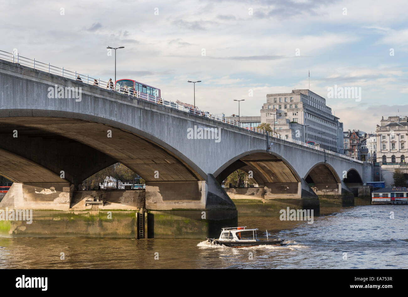 Arches of Waterloo Bridge and the River Thames, with passing boat ...
