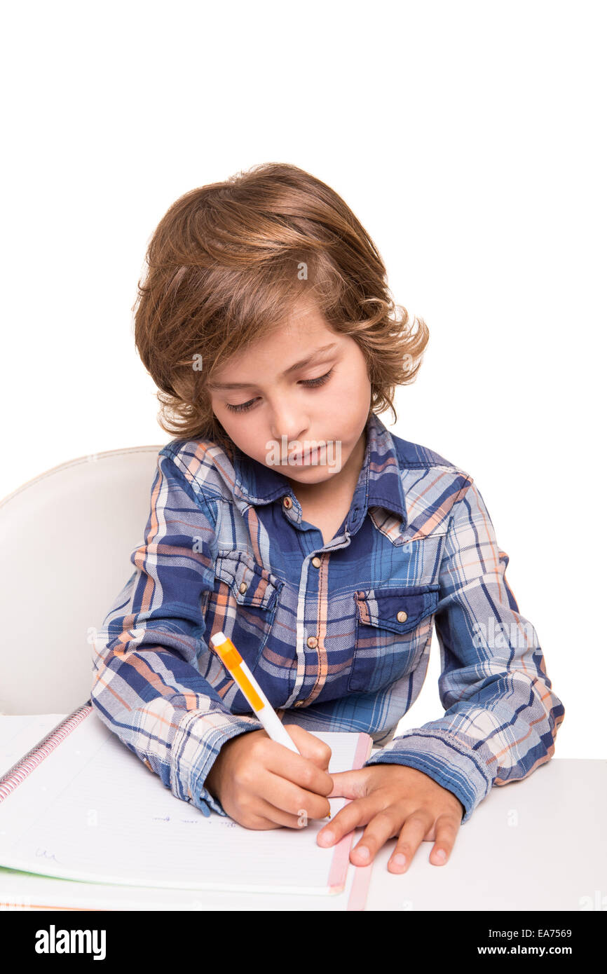 Student boy writing for homework at his desk Stock Photo - Alamy