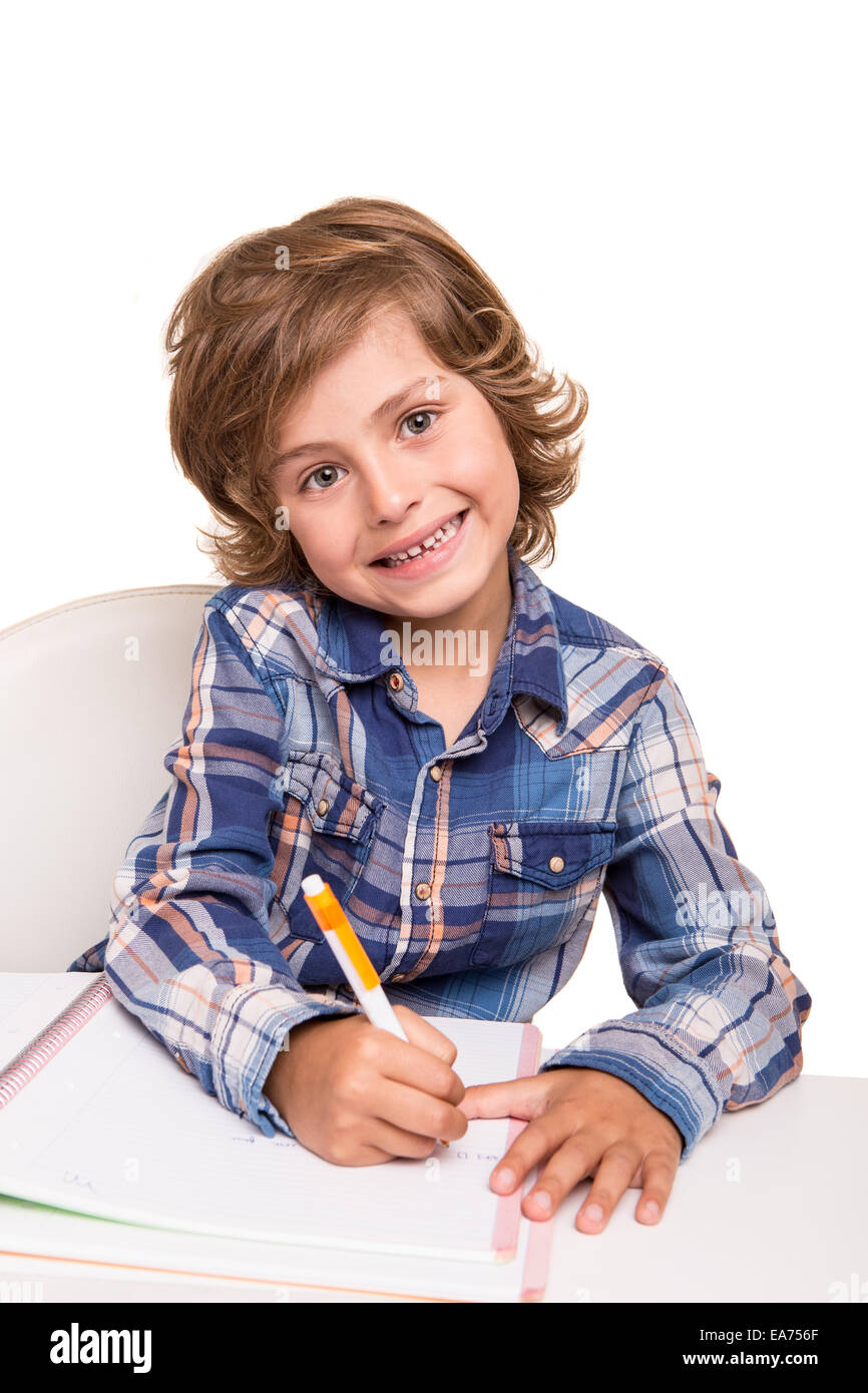 Student boy writing for homework at his desk Stock Photo - Alamy