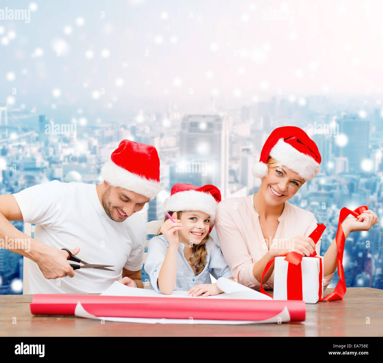 happy family in santa helper hats packing gift Stock Photo - Alamy